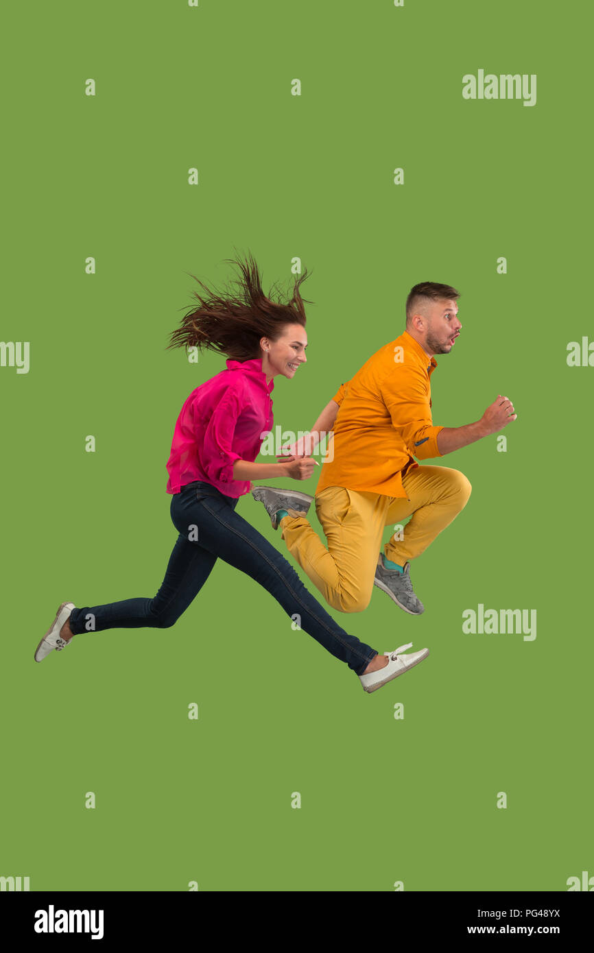 Freedom in moving and forward motion. The happy young couple jumping ...