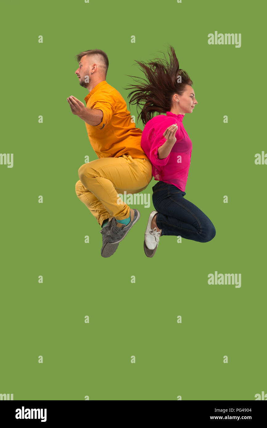Freedom in moving and forward motion. The happy young couple jumping ...