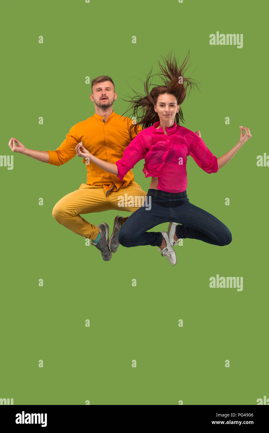 Freedom in moving and forward motion. The happy young couple jumping ...