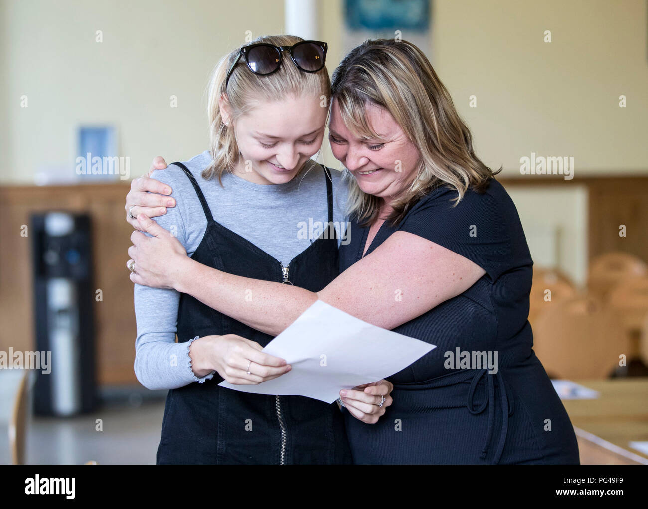 Joanna Milton (left) collects her GCSE results with mum Rachel Milton ...
