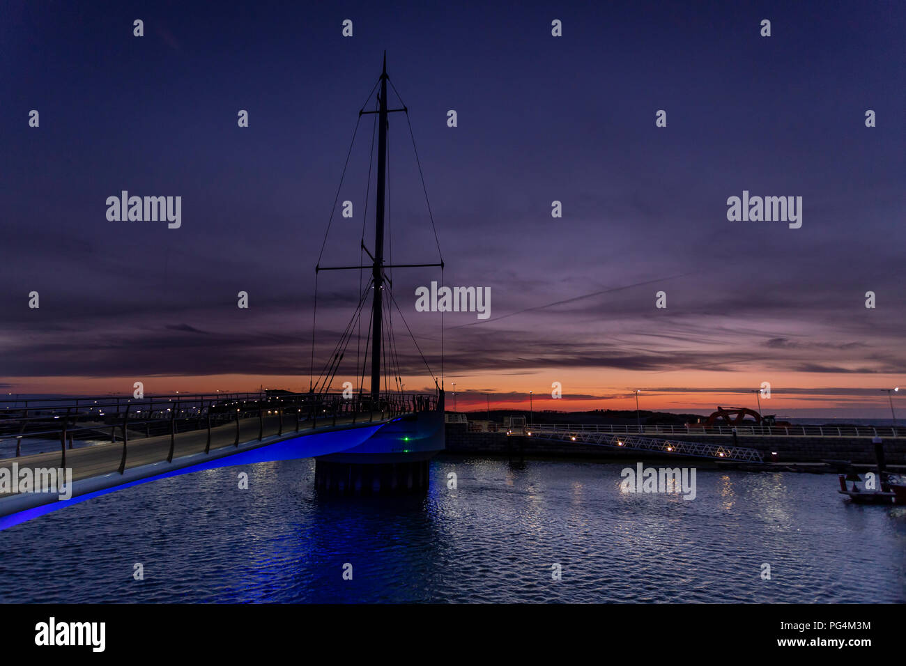 Pont y Ddraig footbridge at dusk, Rhyl harbour, on the North Wales ...
