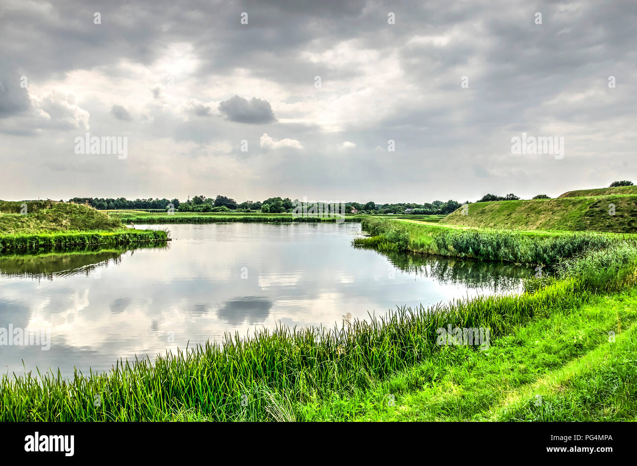 A dramatic sky reflecting in one of the canals around the fortified ...
