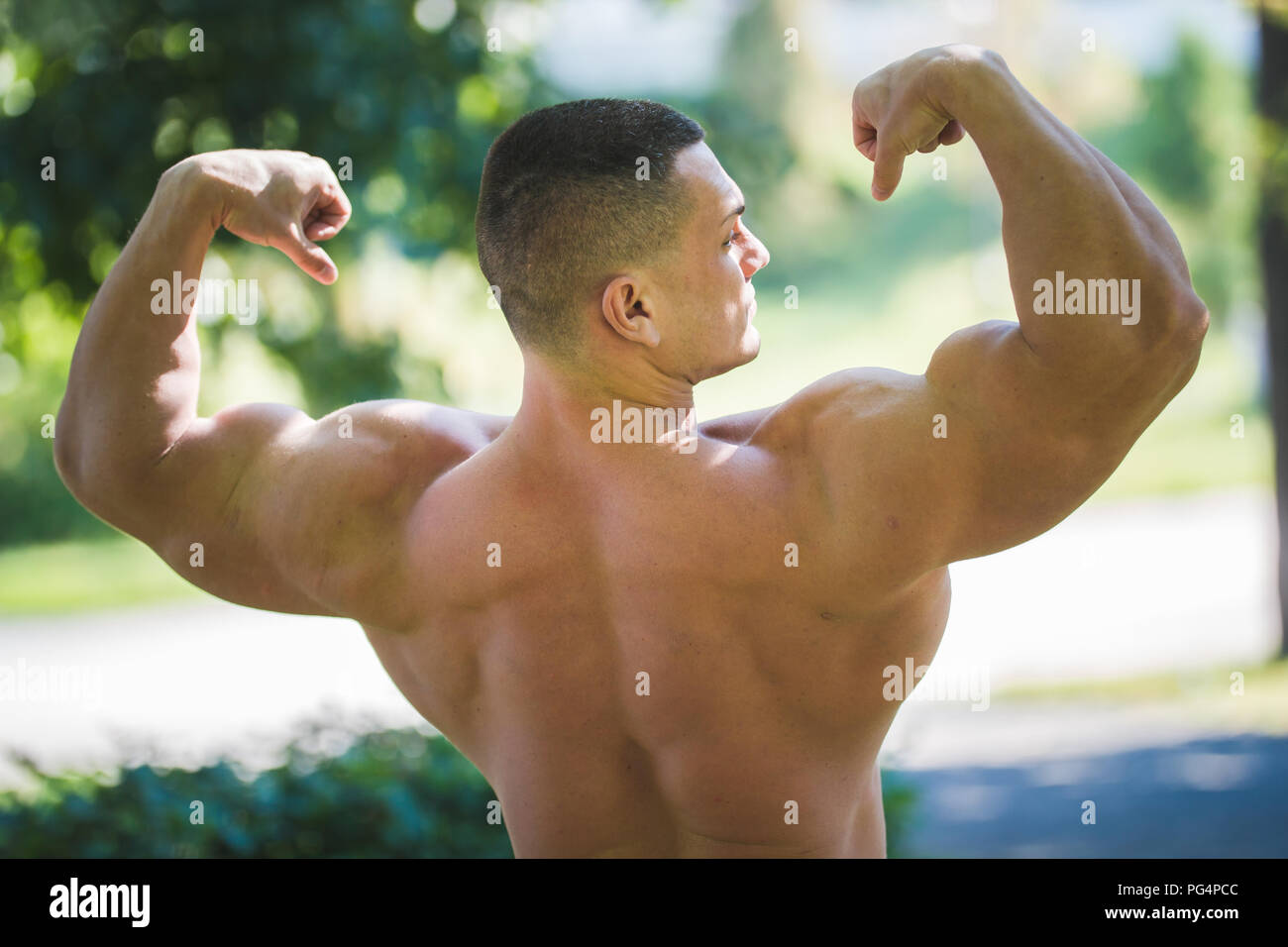 Man a strong inflated body shows off the muscles on his body in the ...