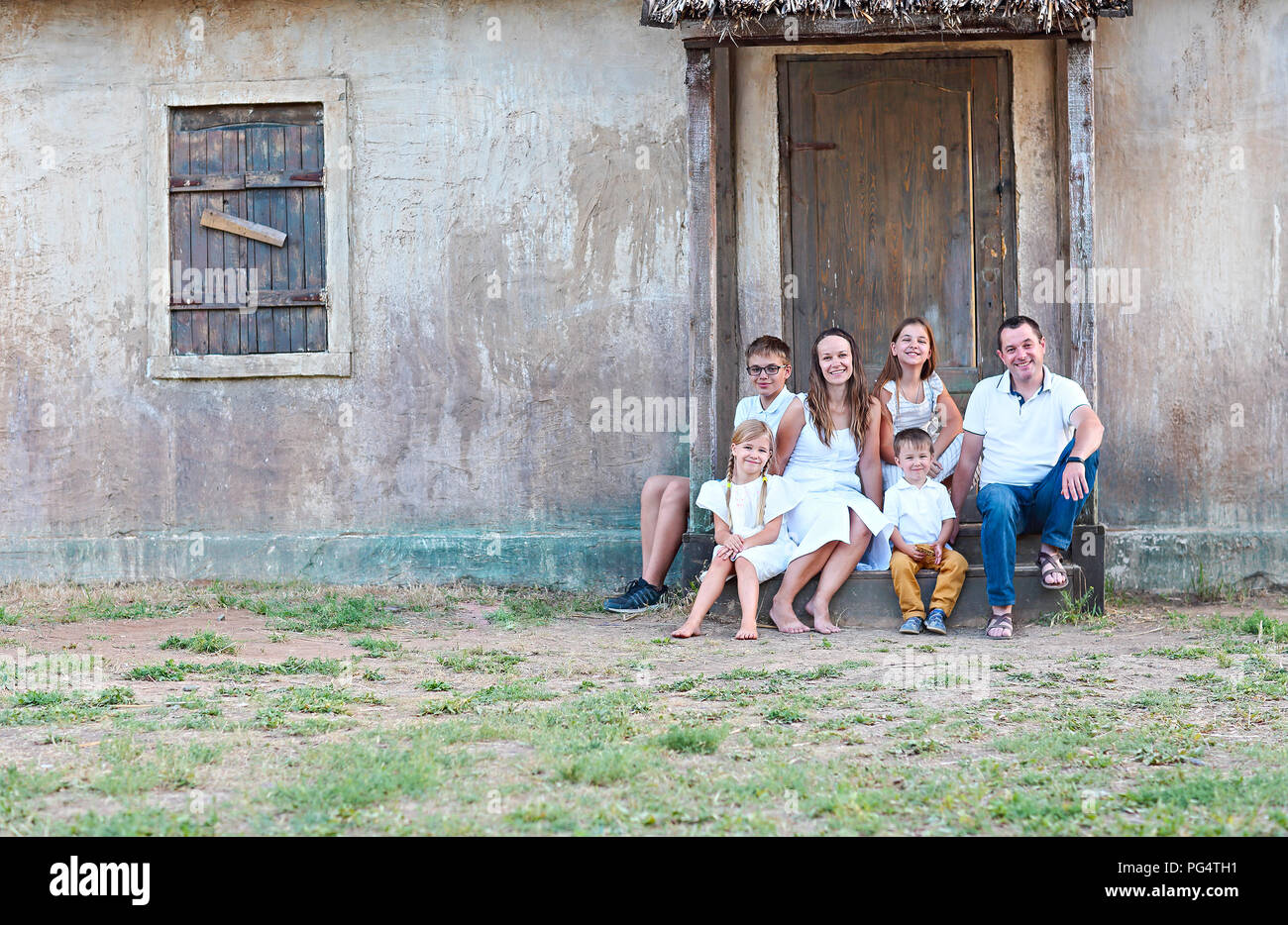 Happy family with five children outdoor near house Stock Photo - Alamy