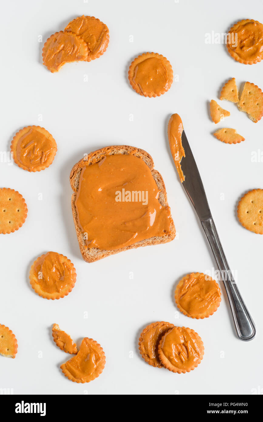 Whole grain peanur butter sandwich, close-up. Crackers, knife, white ...