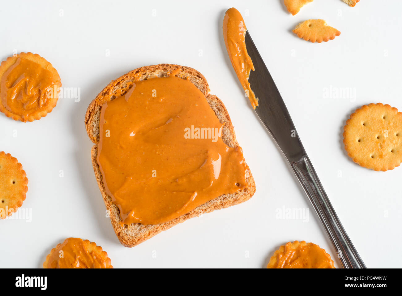 Whole wheat peanut butter sandwich, close-up. Knife, crackers, white ...