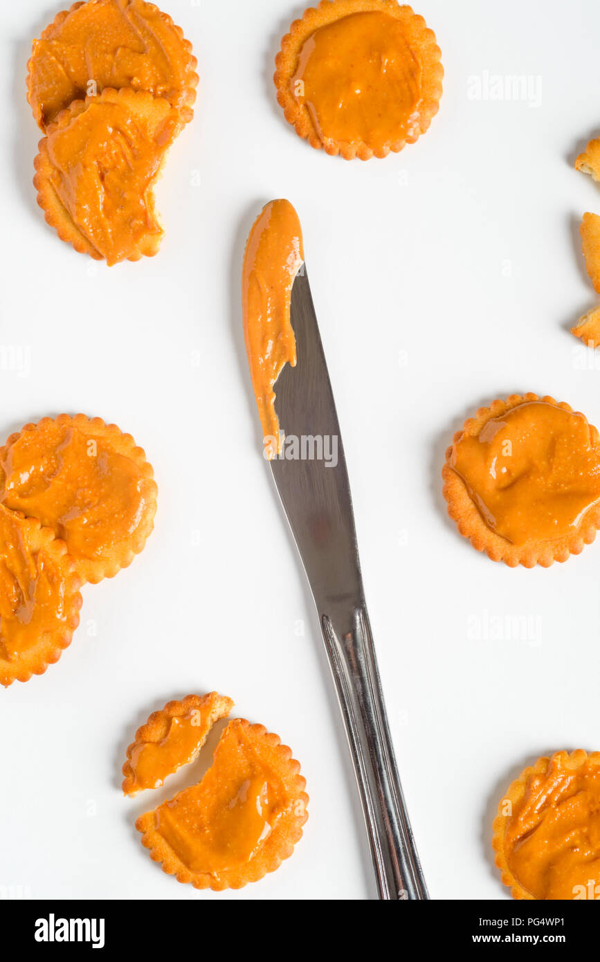 Yummy crackers with peanut butter, close-up, top-view. Knife, white ...