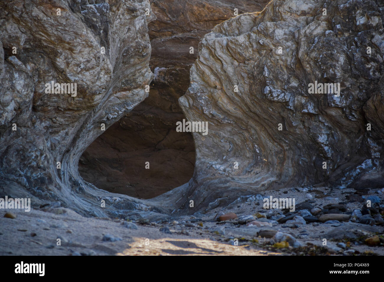 Hole between the rocks in the beach Stock Photo - Alamy