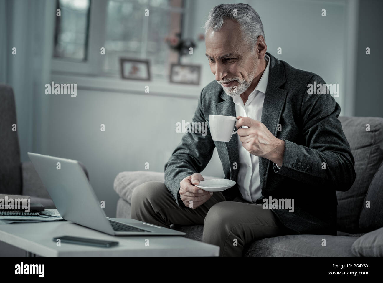 Concentrated man staring at screen of his gadget Stock Photo - Alamy