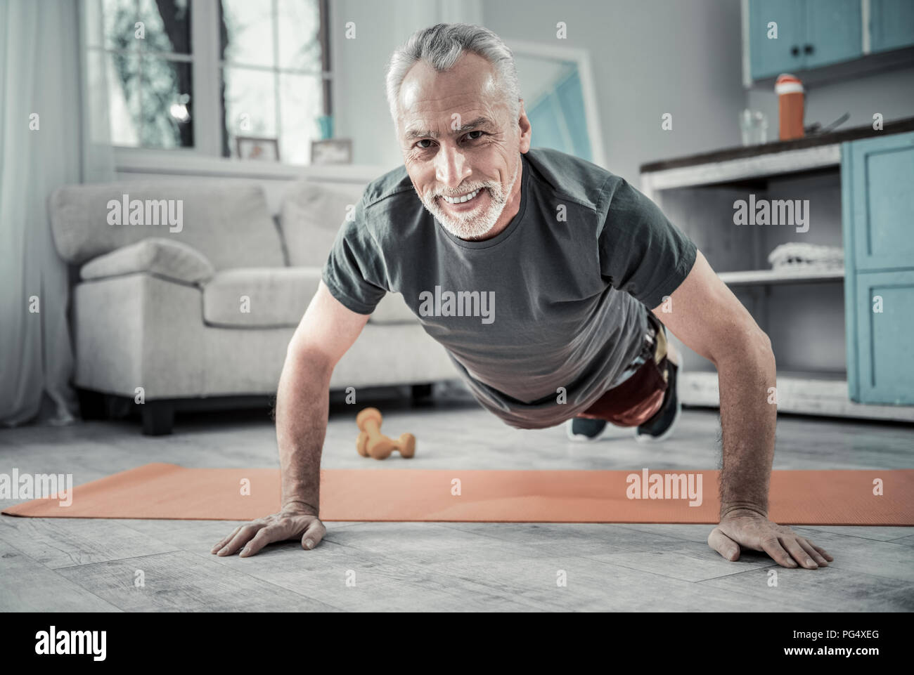 Positive delighted senior sportsman doing push-ups Stock Photo - Alamy