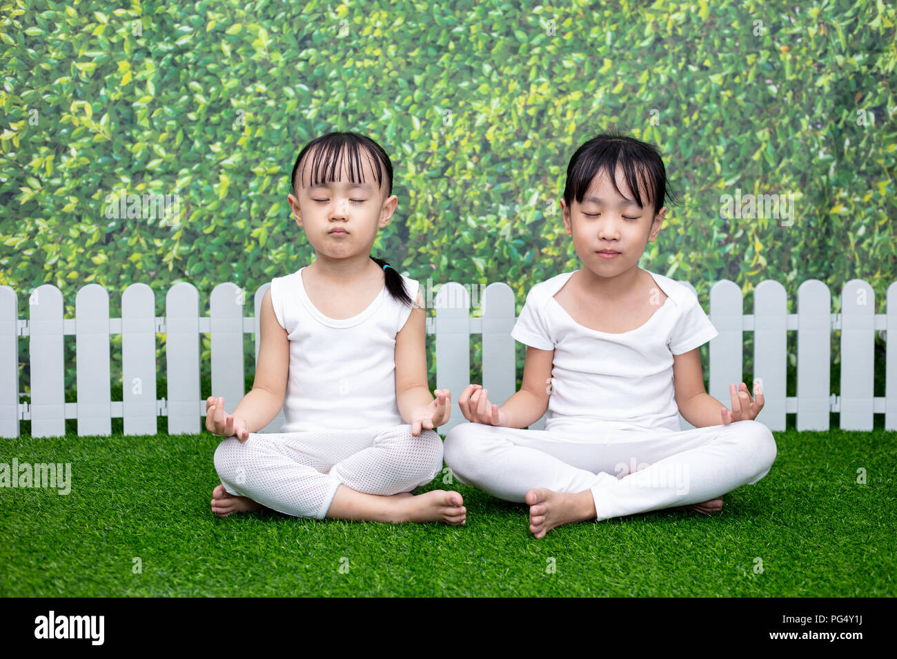 Asian Chinese little girls practicing yoga pose on a mat outdoor Stock ...