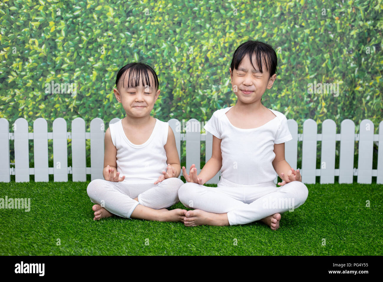 Asian Chinese little girls practicing yoga pose on a mat outdoor Stock ...