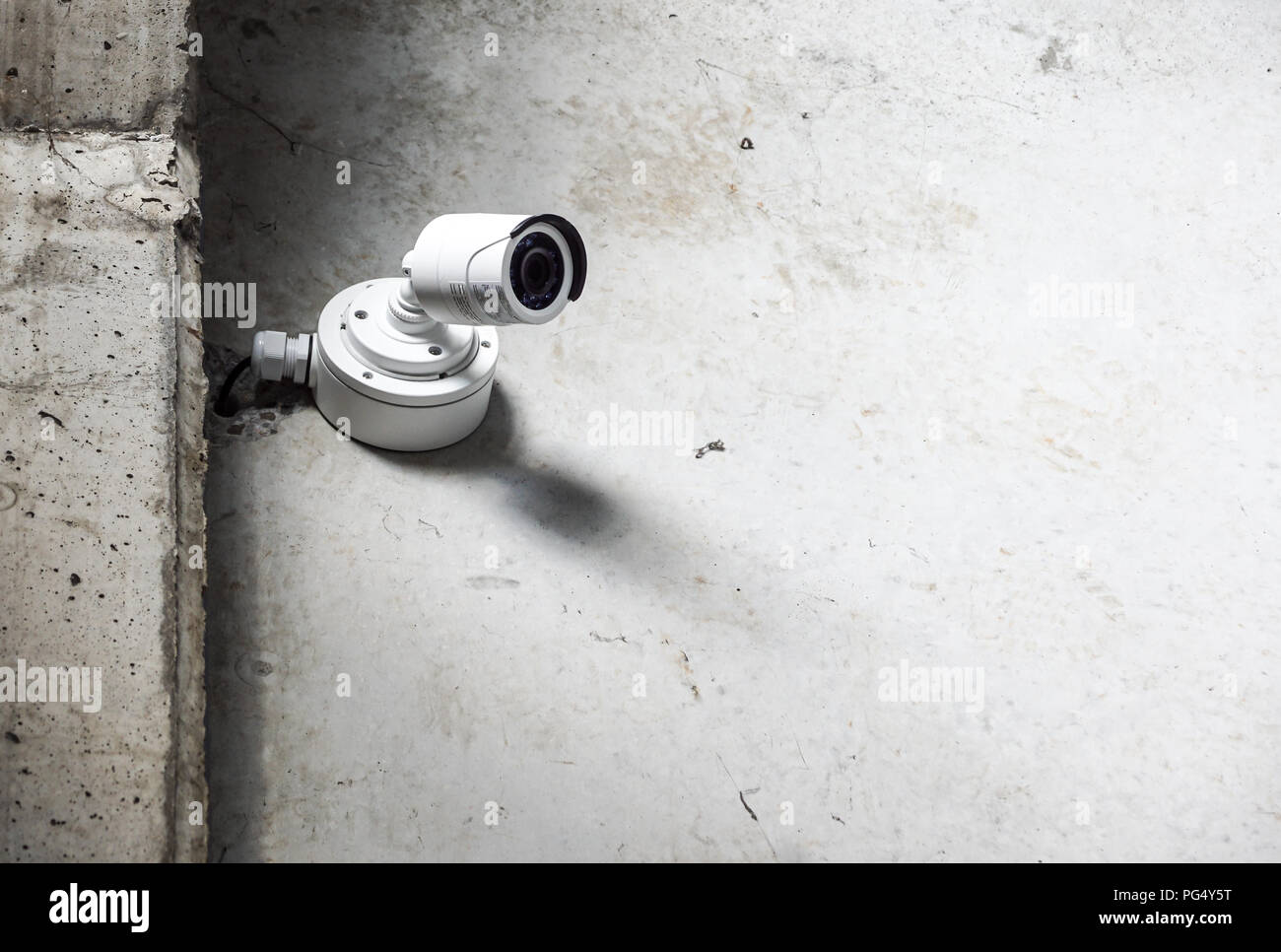 Grunge security camera with shadow on the public cement concrete wall ...