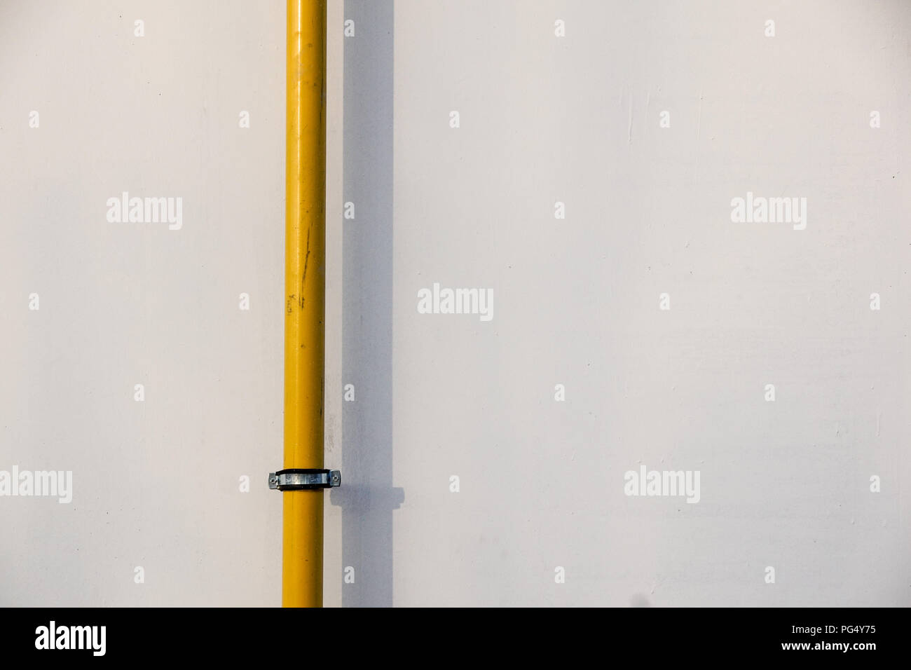 Yellow gas pipe in front of residential building wall Stock Photo - Alamy