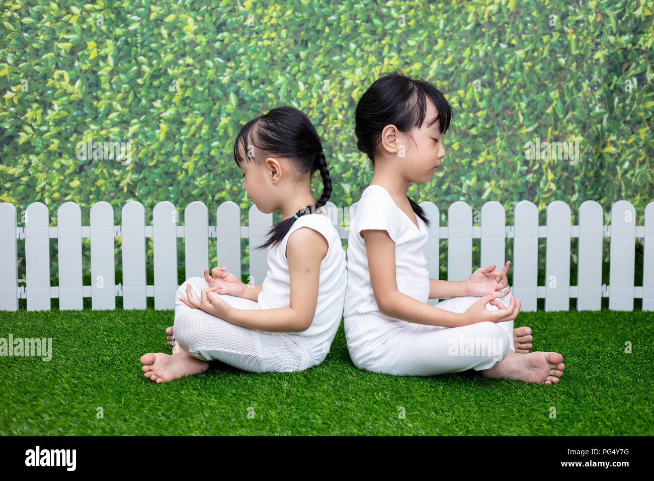 Asian Chinese little girls practicing yoga pose on a mat outdoor Stock ...