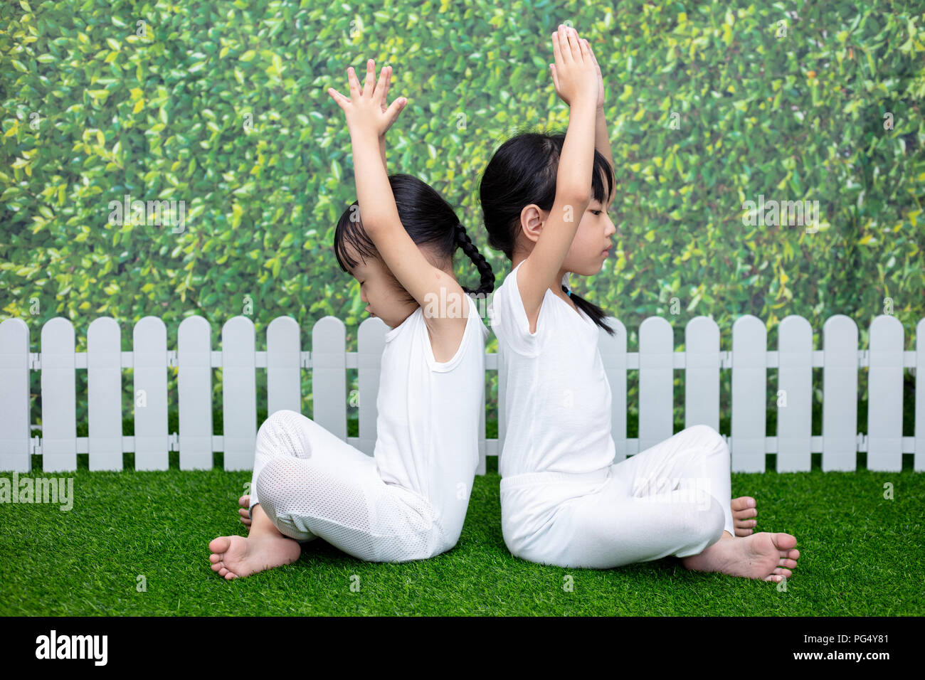 Asian Chinese little girls practicing yoga pose on a mat outdoor Stock ...