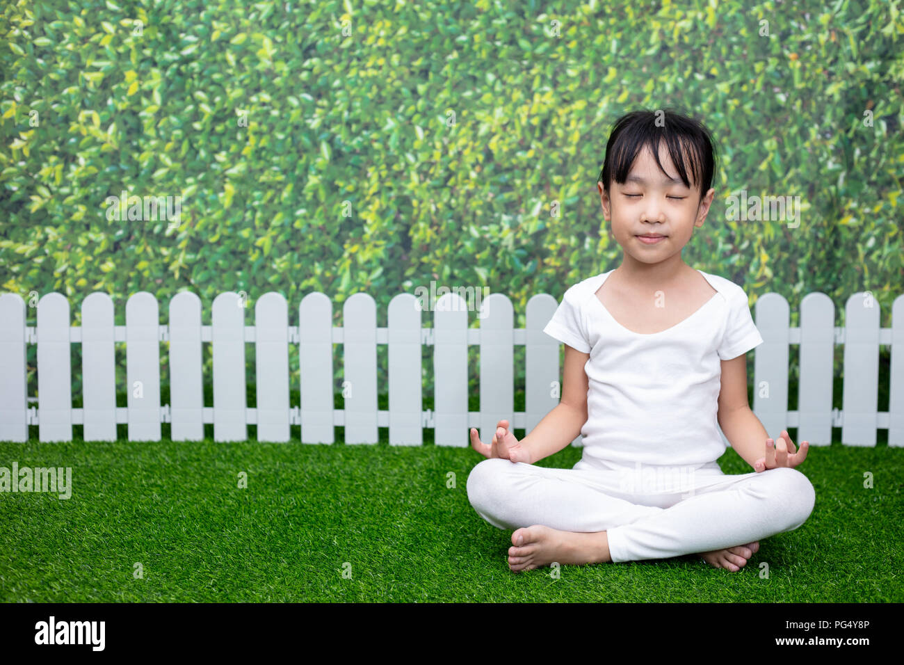 Asian Chinese little girl practicing yoga pose on a mat outdoor Stock ...