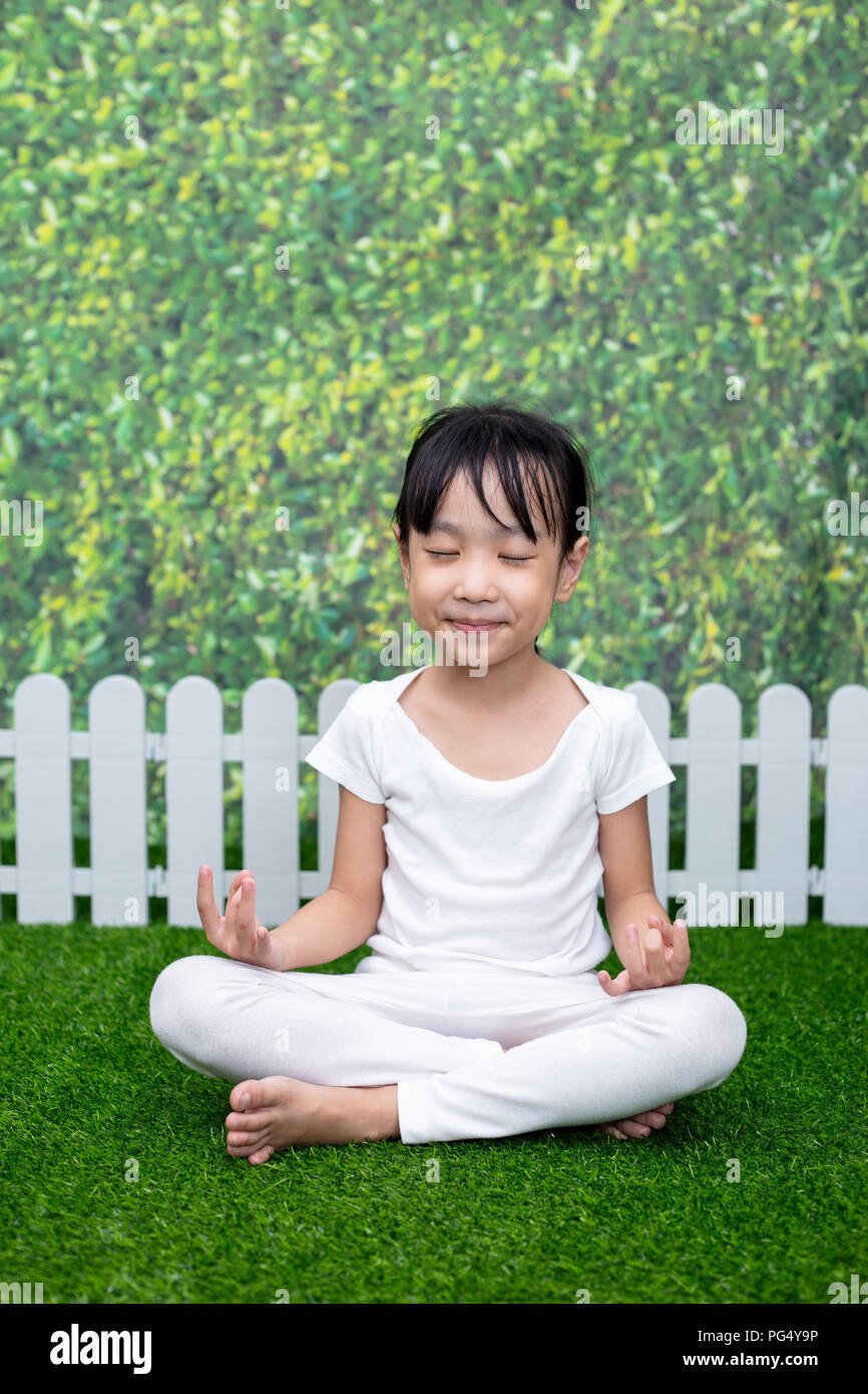 Asian Chinese little girl practicing yoga pose on a mat outdoor Stock ...