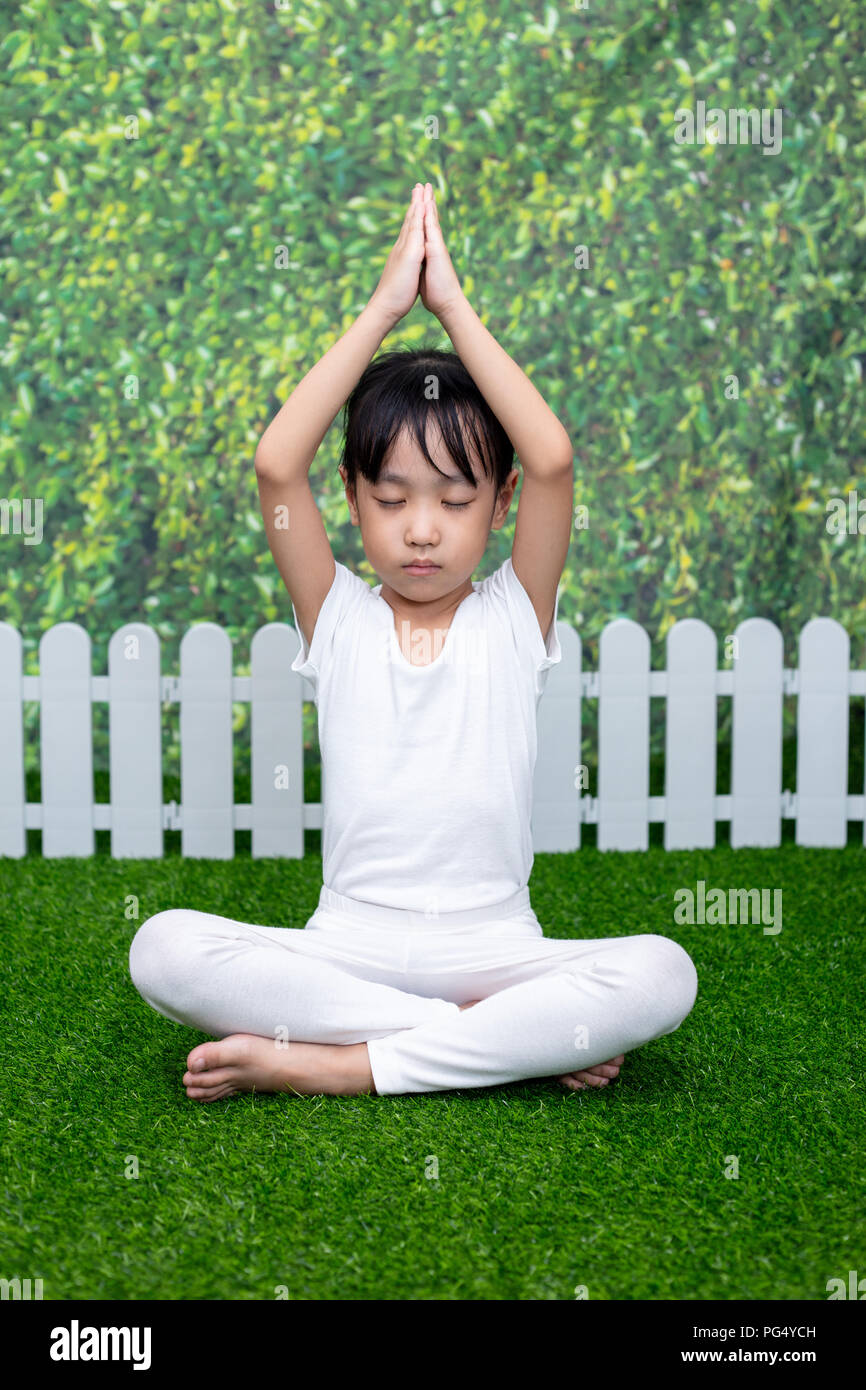 Asian Chinese little girl practicing yoga pose on a mat outdoor Stock ...