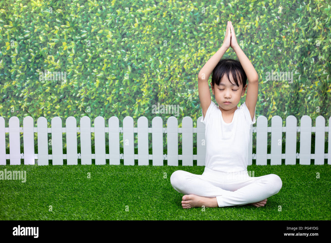 Asian Chinese little girl practicing yoga pose on a mat outdoor Stock ...