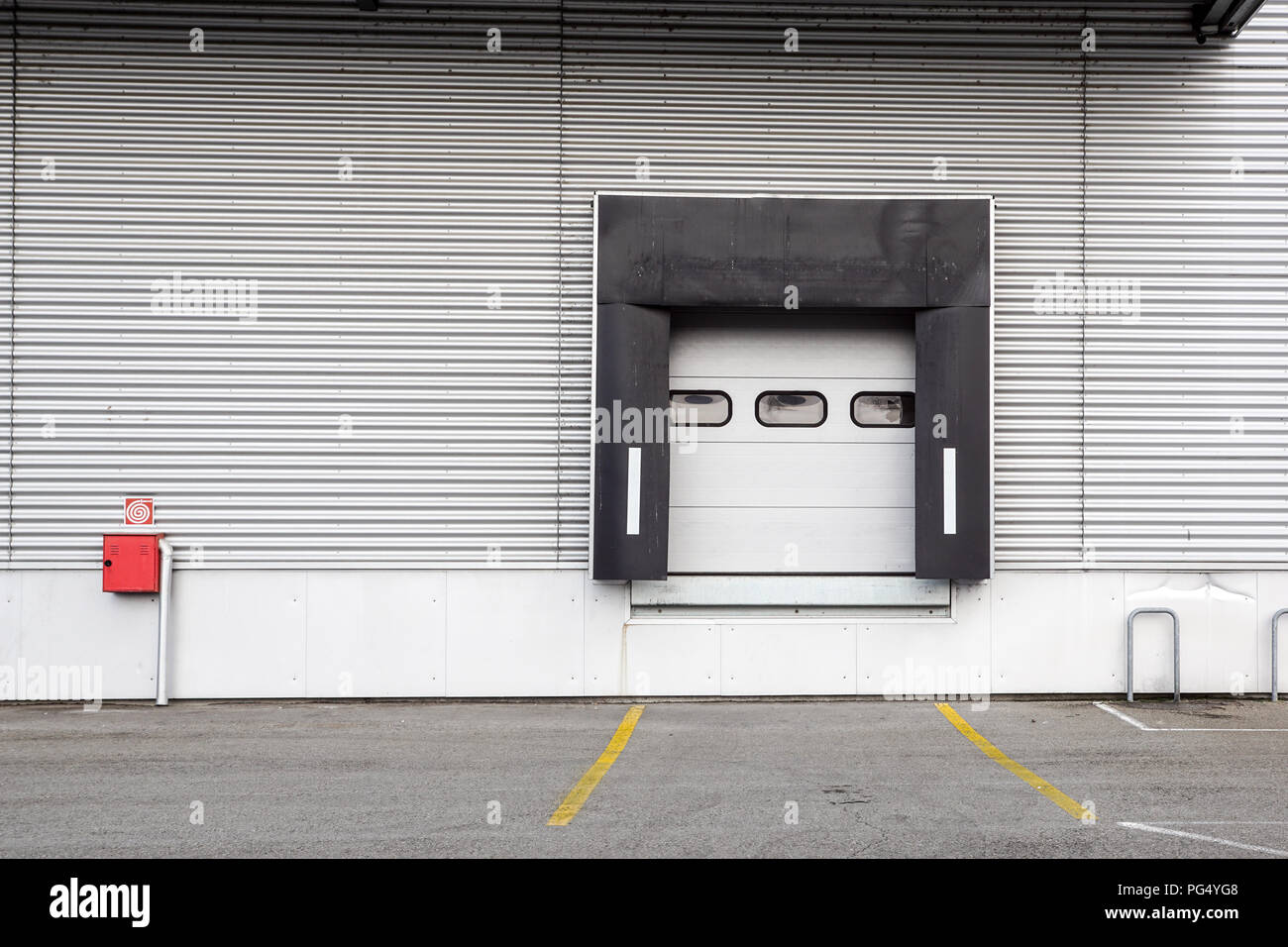 Roller shutter door and concrete floor inside factory building for ...