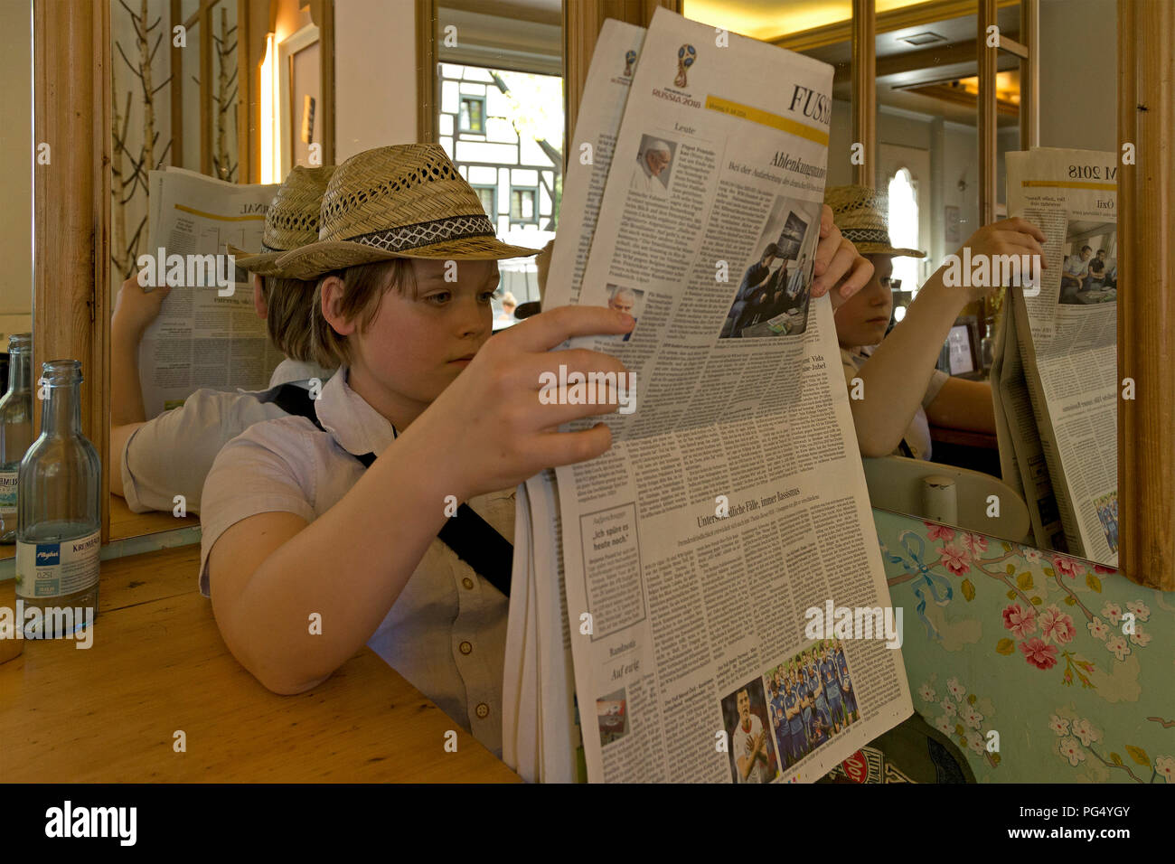 Boy reading newspaper hi-res stock photography and images - Alamy