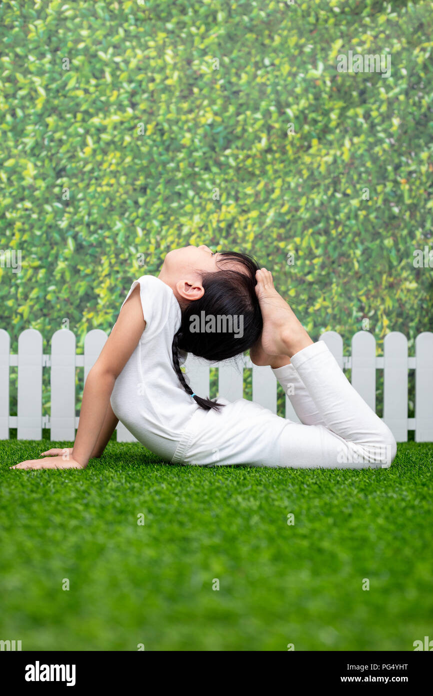 Asian Chinese little girl practicing yoga pose on a mat outdoor Stock ...
