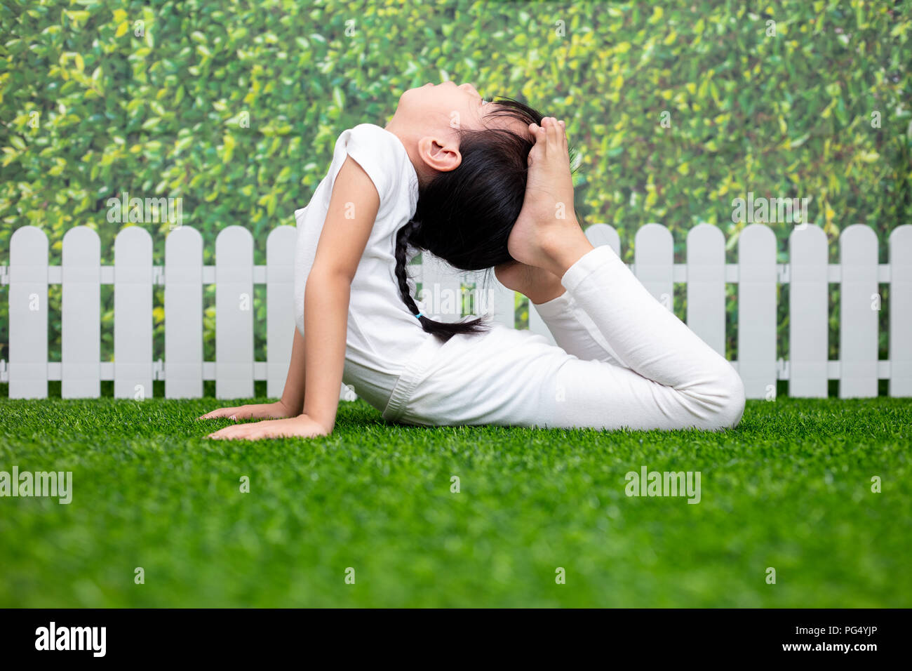 Asian Chinese little girl practicing yoga pose on a mat outdoor Stock ...