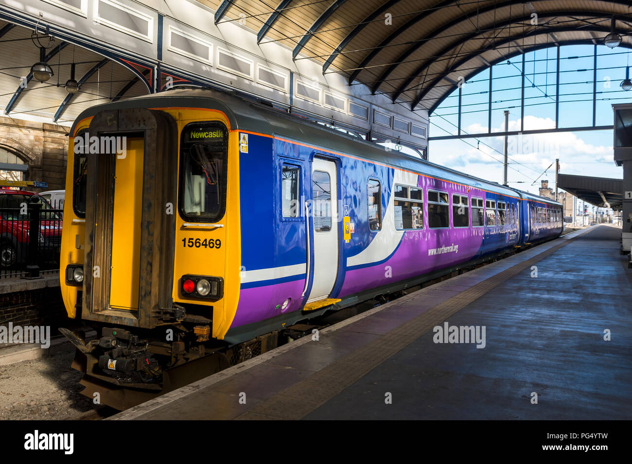 Northern Rail class 156 sprinter passenger train waiting at a station in Yorkshire, England ...
