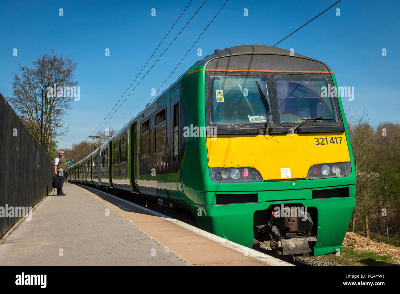 Class 321 passenger train in London Midland livery waiting at a small ...