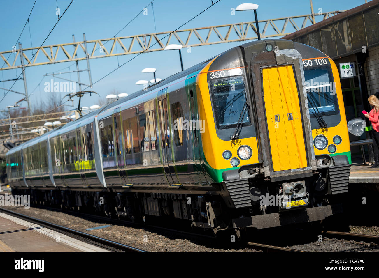 London Midland trains passenger train class 350 travelling at a station on the Abbey Line ...