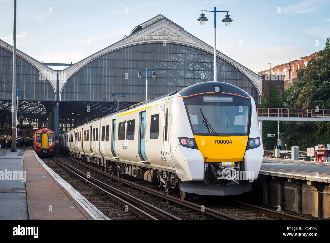 Class 700 passenger train in Thameslink livery waiting at a railway ...