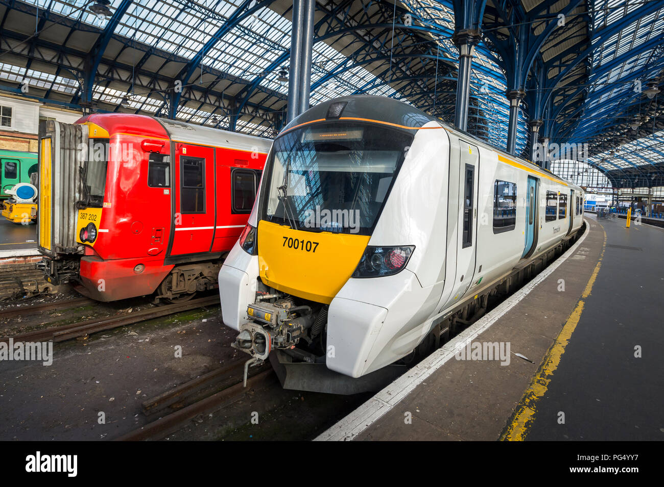 Class 700 passenger train in Thameslink livery waiting next to a ...