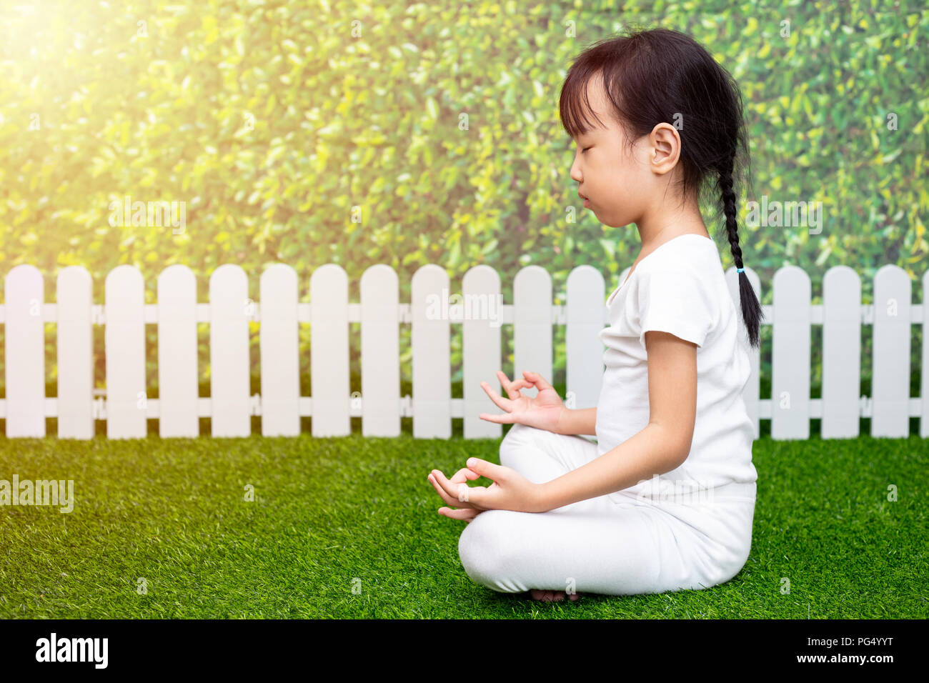 Asian Chinese little girl practicing yoga pose on a mat outdoor Stock ...