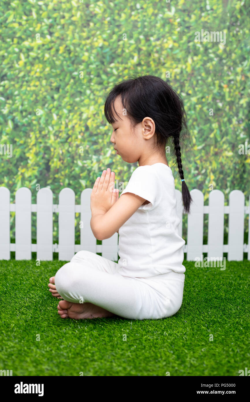 Asian Chinese little girl practicing yoga pose on a mat outdoor Stock ...