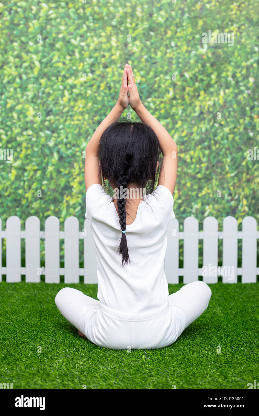 Asian Chinese little girl practicing yoga pose on a mat outdoor Stock ...