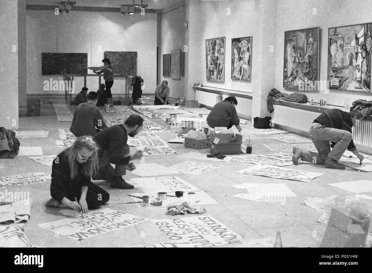 Activists paint signs in a gallery for a protest march against the ...