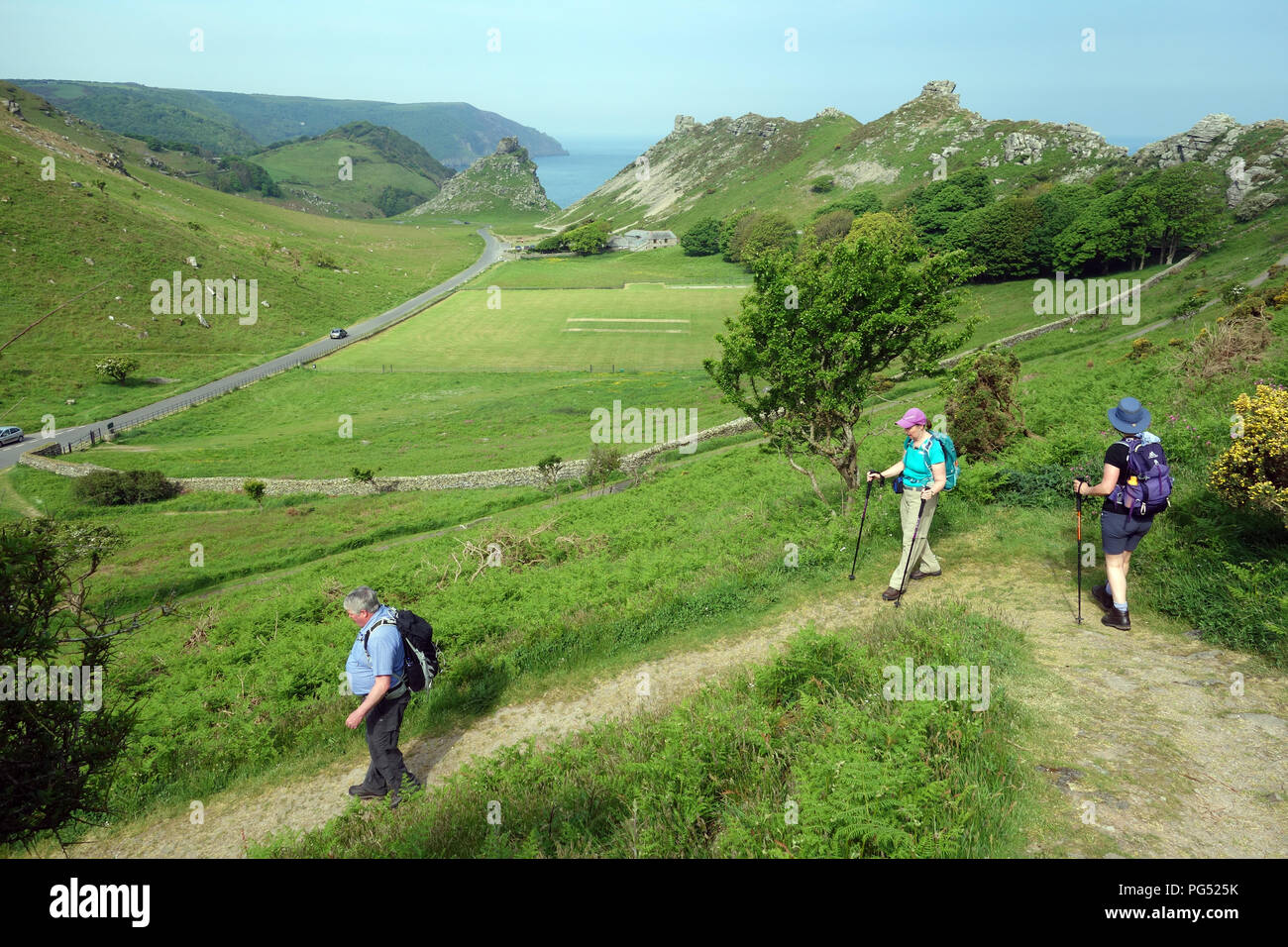 Three People Walking down Hollerday Hill Towards Castle Rock in the ...