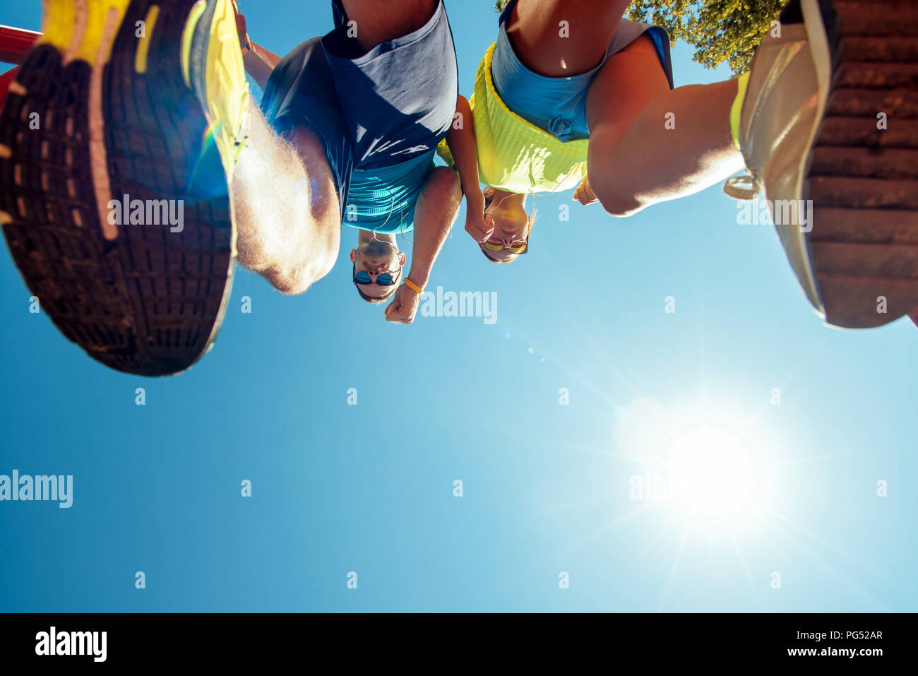 Bottom view cropped image of two people in sneakers Stock Photo - Alamy