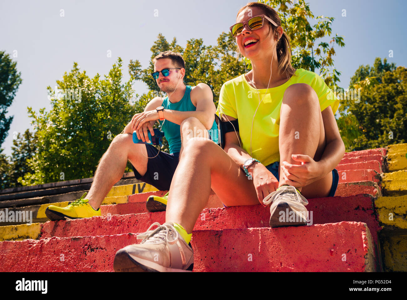 Runners resting taking a break drinking water after running outside ...