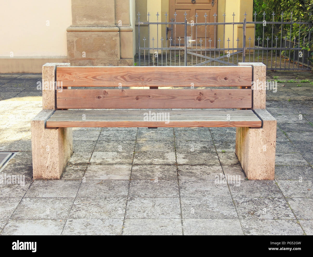 Wooden bench in front of a fence Stock Photo - Alamy