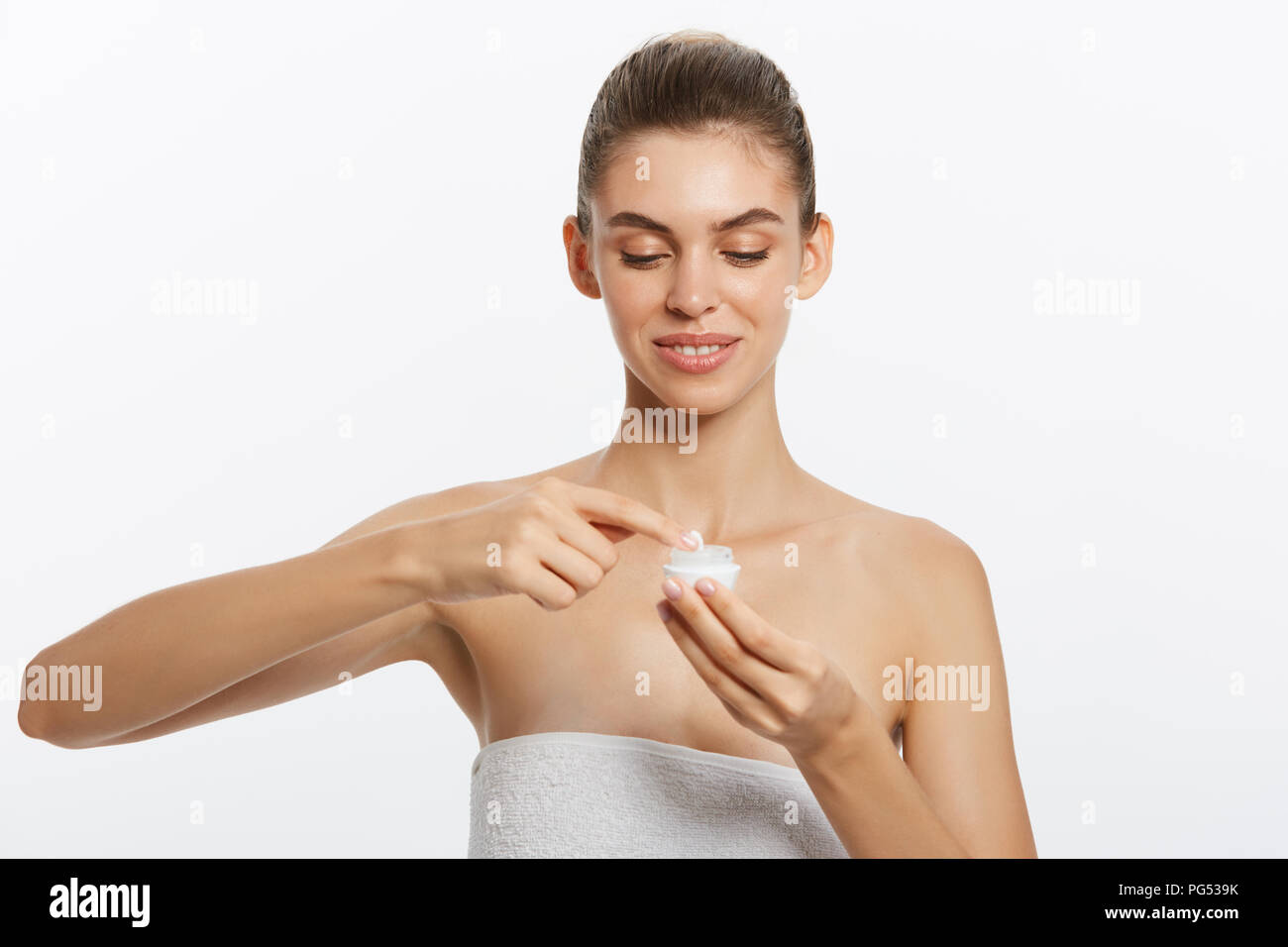 Portrait Of Young Woman Applying Moisturizer Cream On Her Pretty Face