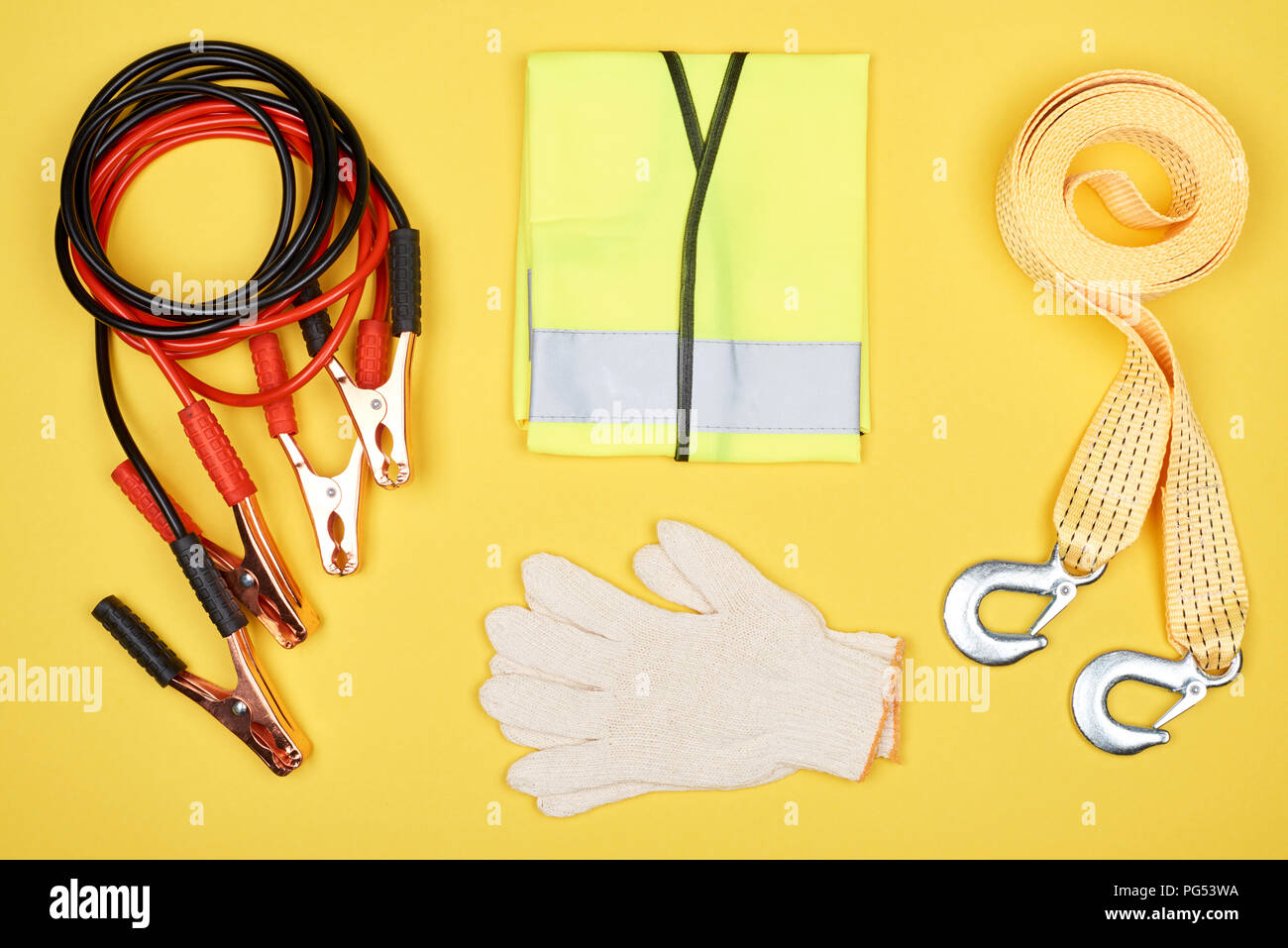 flat lay with arrangement of automotive accessories isolated on yellow ...