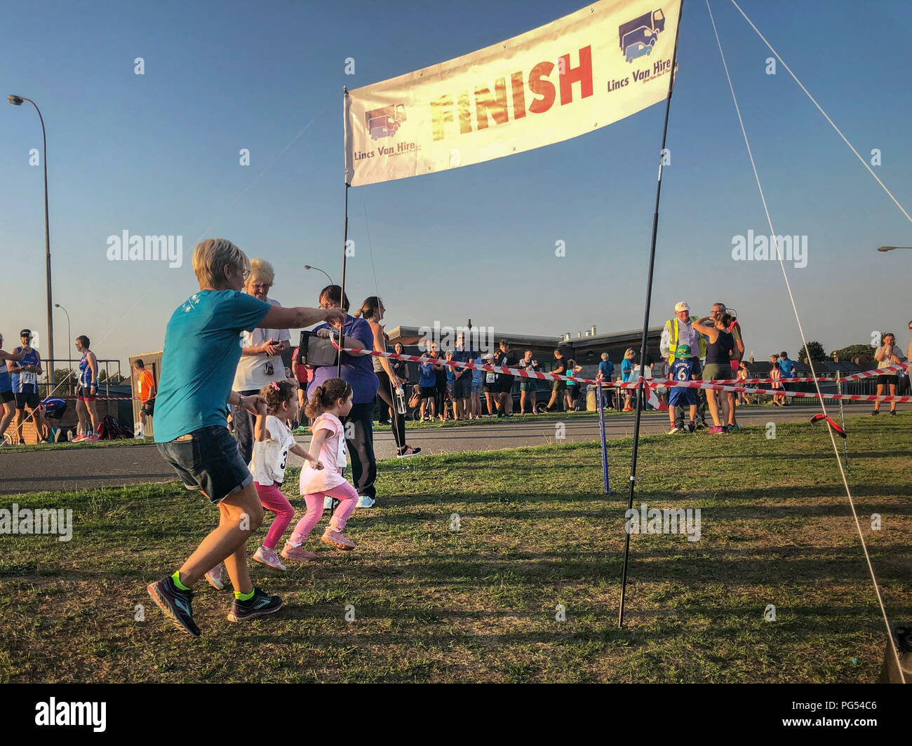 Child running finish line hi-res stock photography and images - Alamy