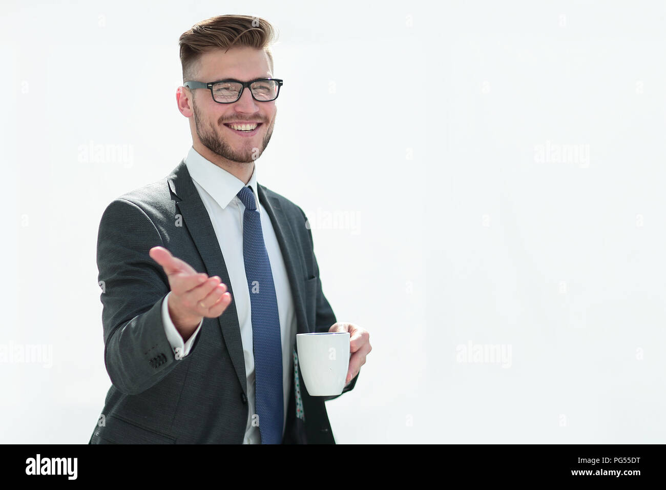 friendly businessman with a Cup of tea invites you Stock Photo - Alamy