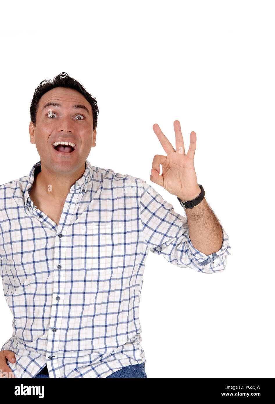 A handsome happy young man with his mouths open signs with his hands it ...