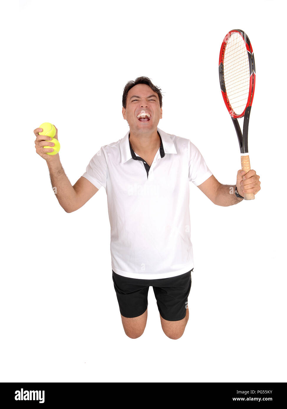 A very happy young man kneeling on the floor celebrating his victory on ...