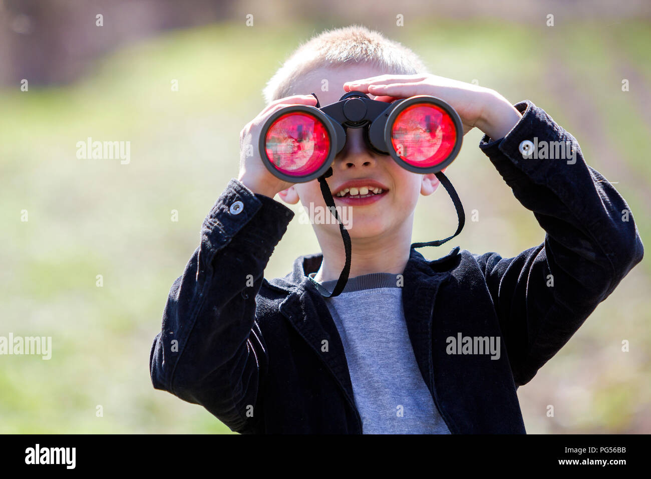 Portrait of little cute handsome cute blond boy watching intently ...