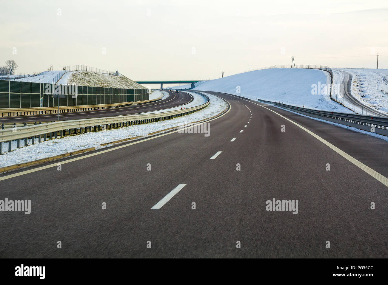 Modern wide smooth empty asphalt highway stretching to horizon under ...