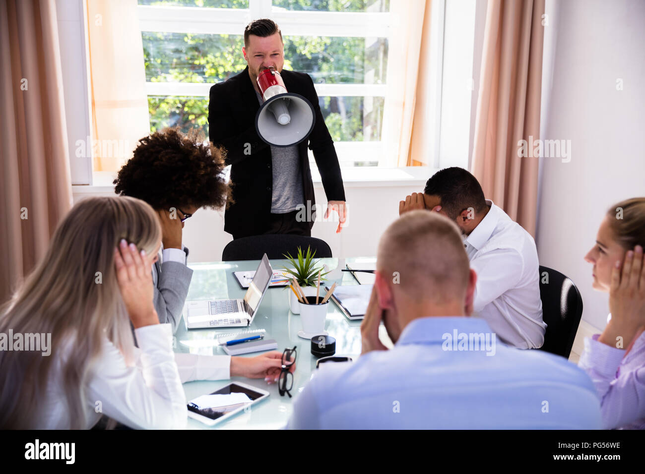 Angry Businessman Shouting At His Colleagues Through Megaphone Stock ...